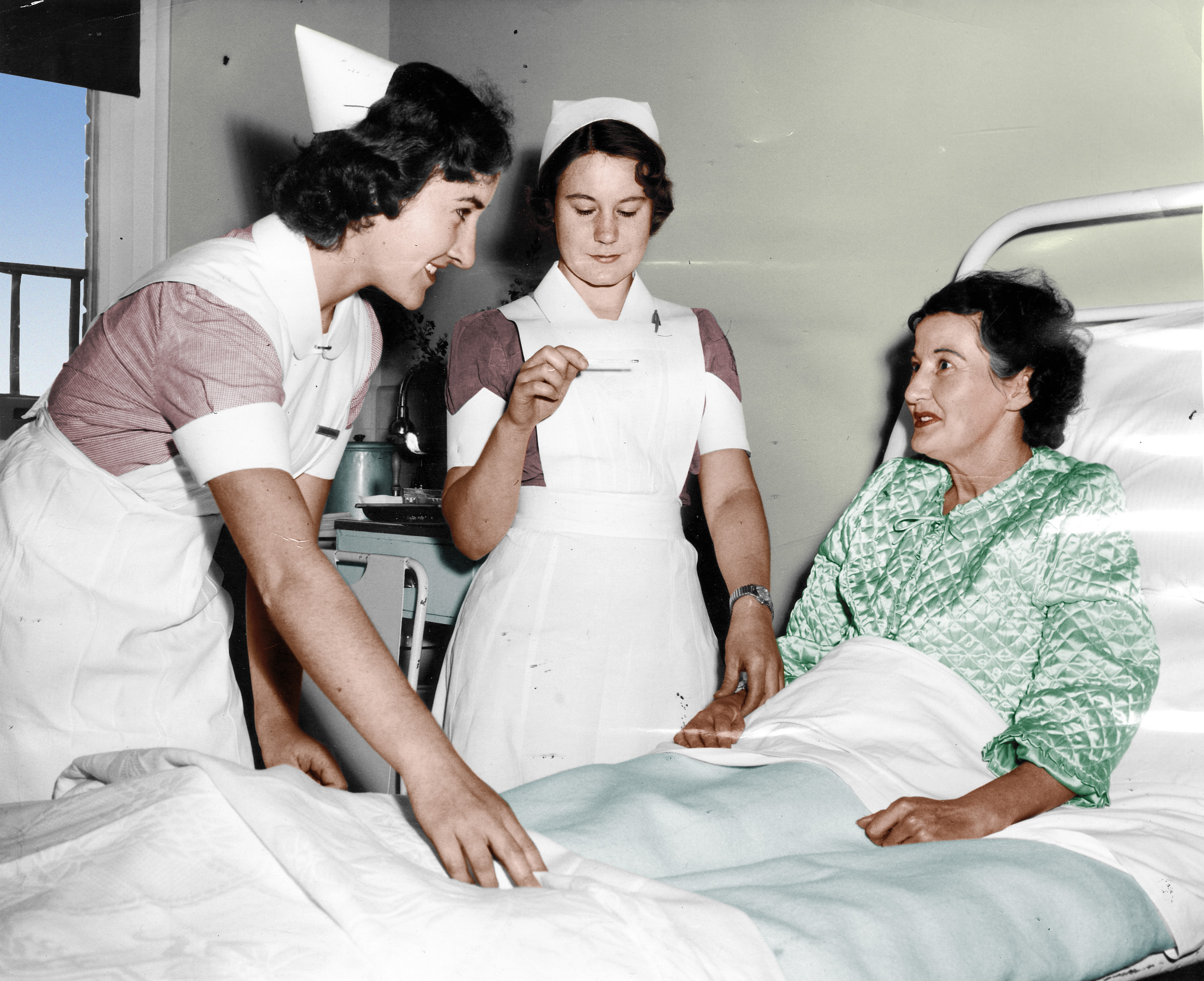 Nurse Ann Young makes a patient comfortable while Helen Ellery takes ...